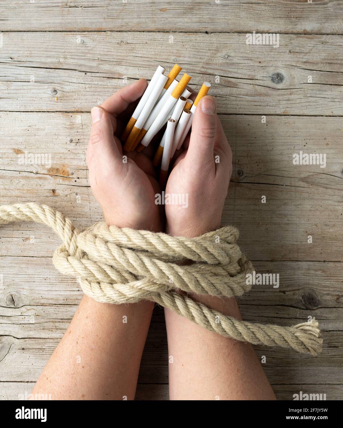 male hands are tied holding cigarettes, concept addiction, smoking ...