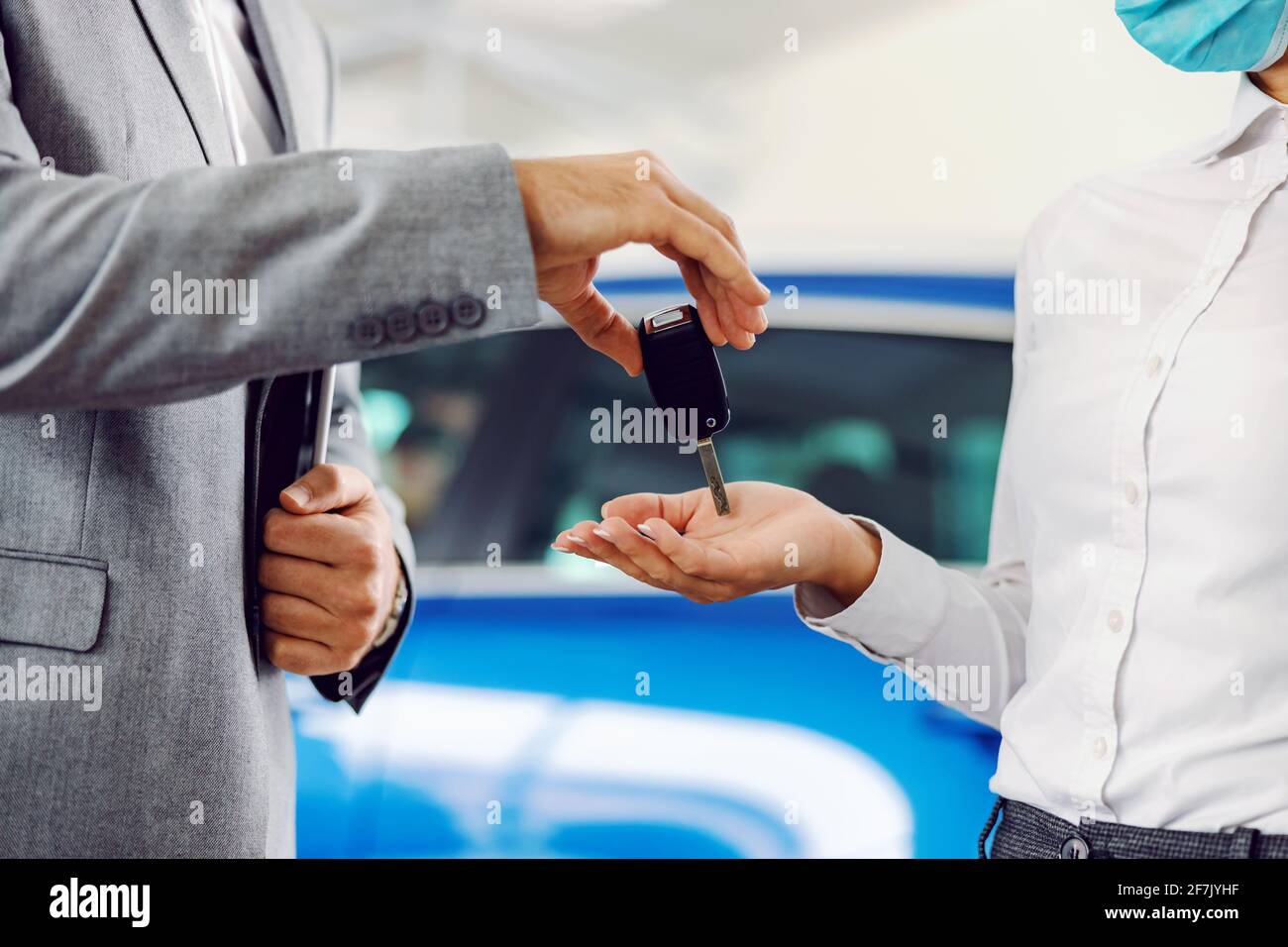Close up of car seller handing car keys to a customer Stock Photo - Alamy