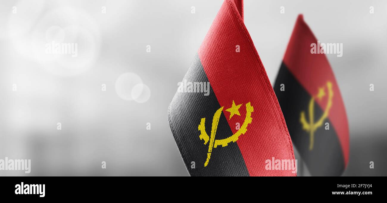 Small national flags of the Angola on a light blurry background Stock ...