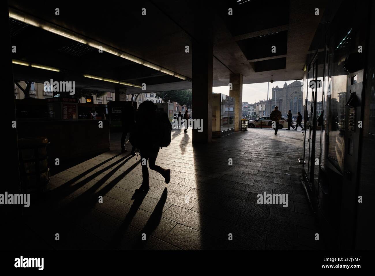 High contrast view of people walking outside the train station of ...