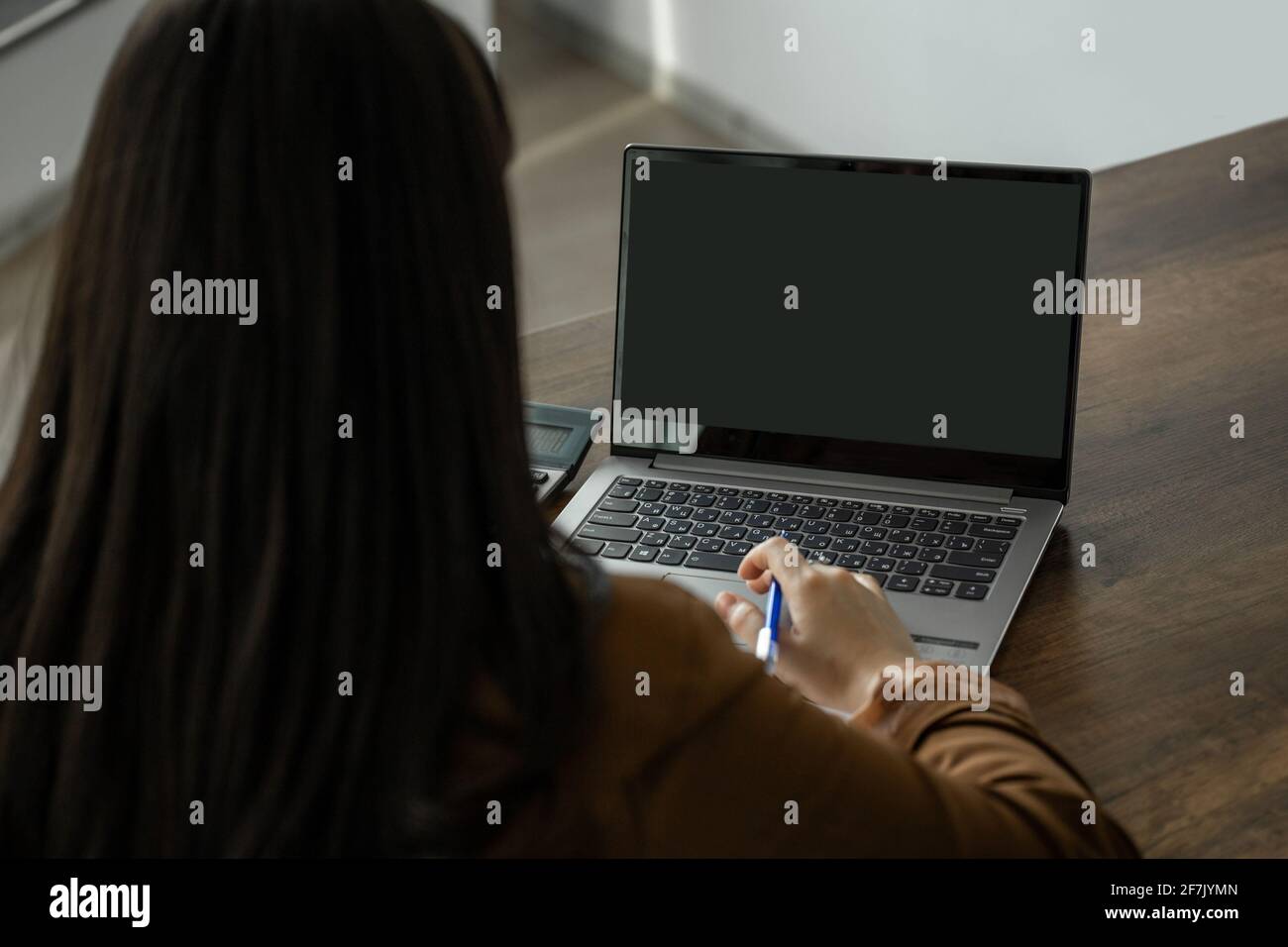 girl at a desk with a laptop from the back Stock Photo - Alamy