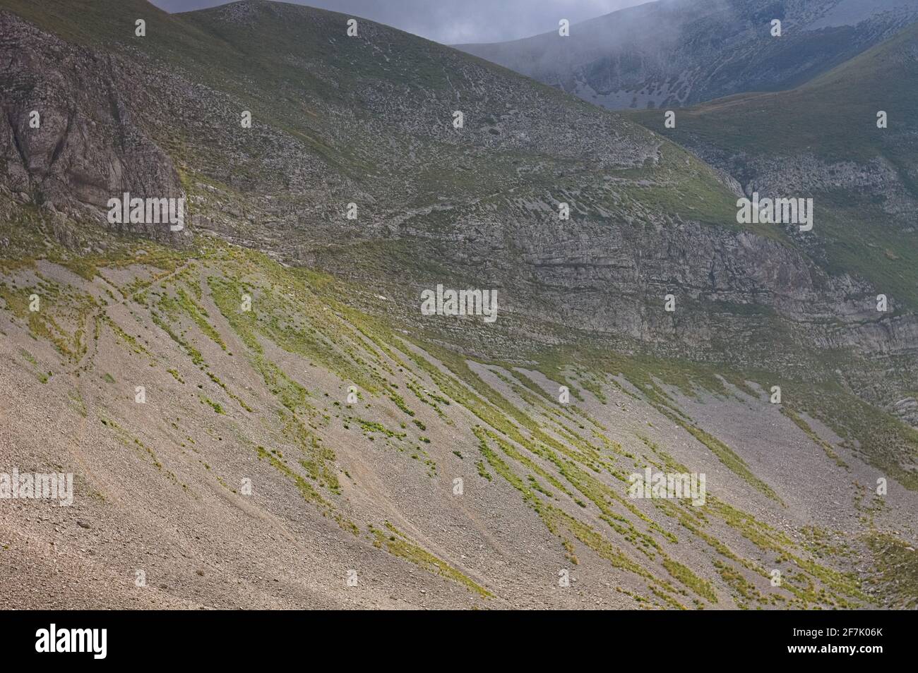 An arid slope in the Sibillini mountains during a foggy day (Marche ...