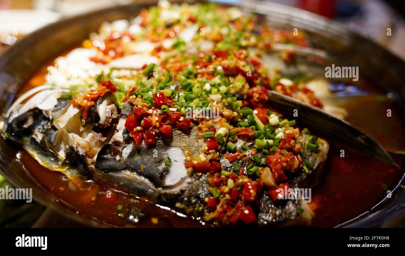 steamed fish head with diced hot red peppers Stock Photo - Alamy
