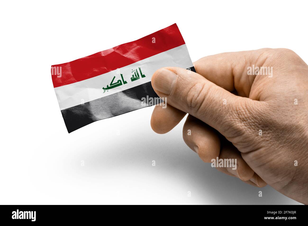 Hand holding a card with a national flag the Iraq Stock Photo - Alamy