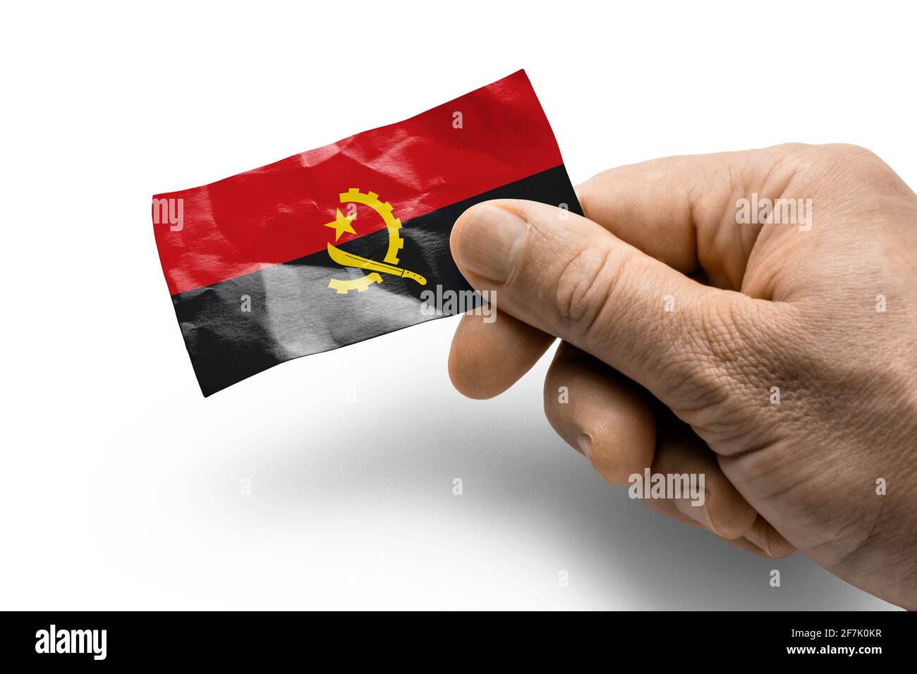 Hand holding a card with a national flag the Angola Stock Photo - Alamy