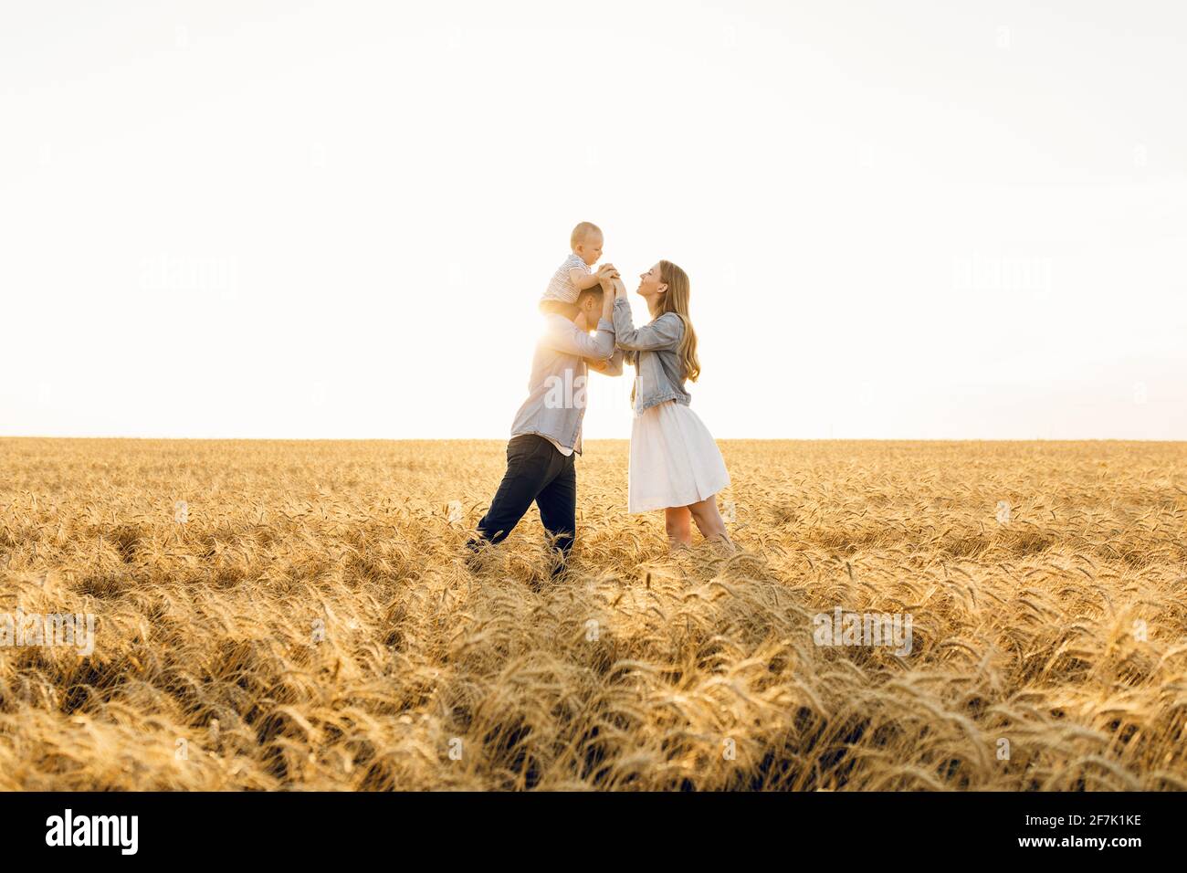 Happy family on a summer walk, mother, father and child walk in the ...