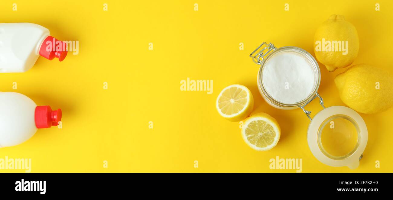 Jar of acid powder, lemons and detergents on yellow background Stock ...