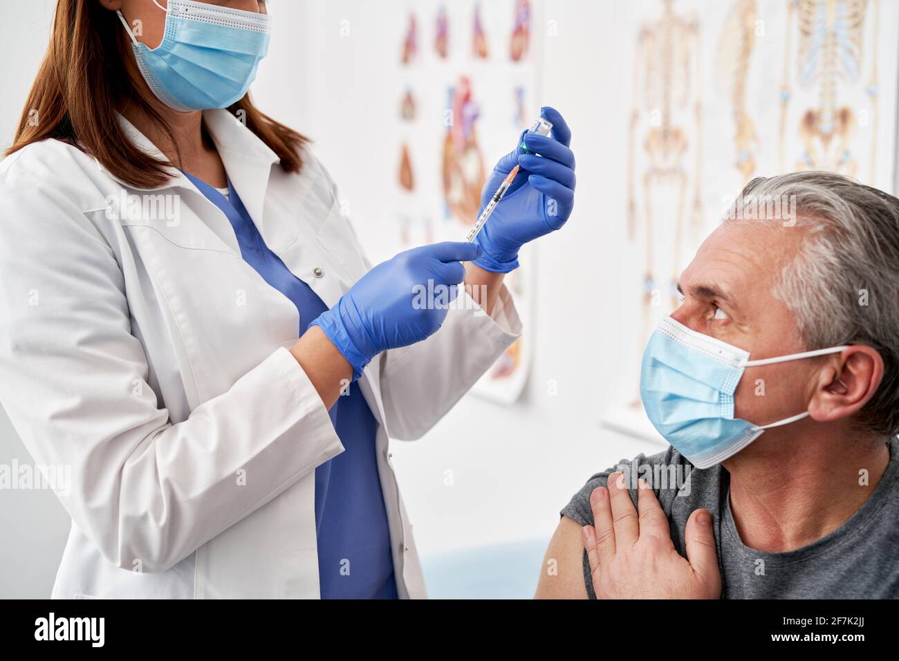 Close up of doctor preparing syringe for senior patient Stock Photo - Alamy