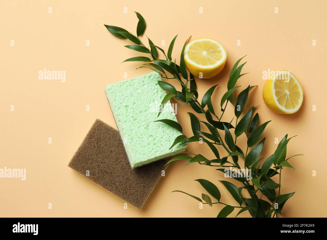 Sponges, branch and lemons on beige background Stock Photo - Alamy