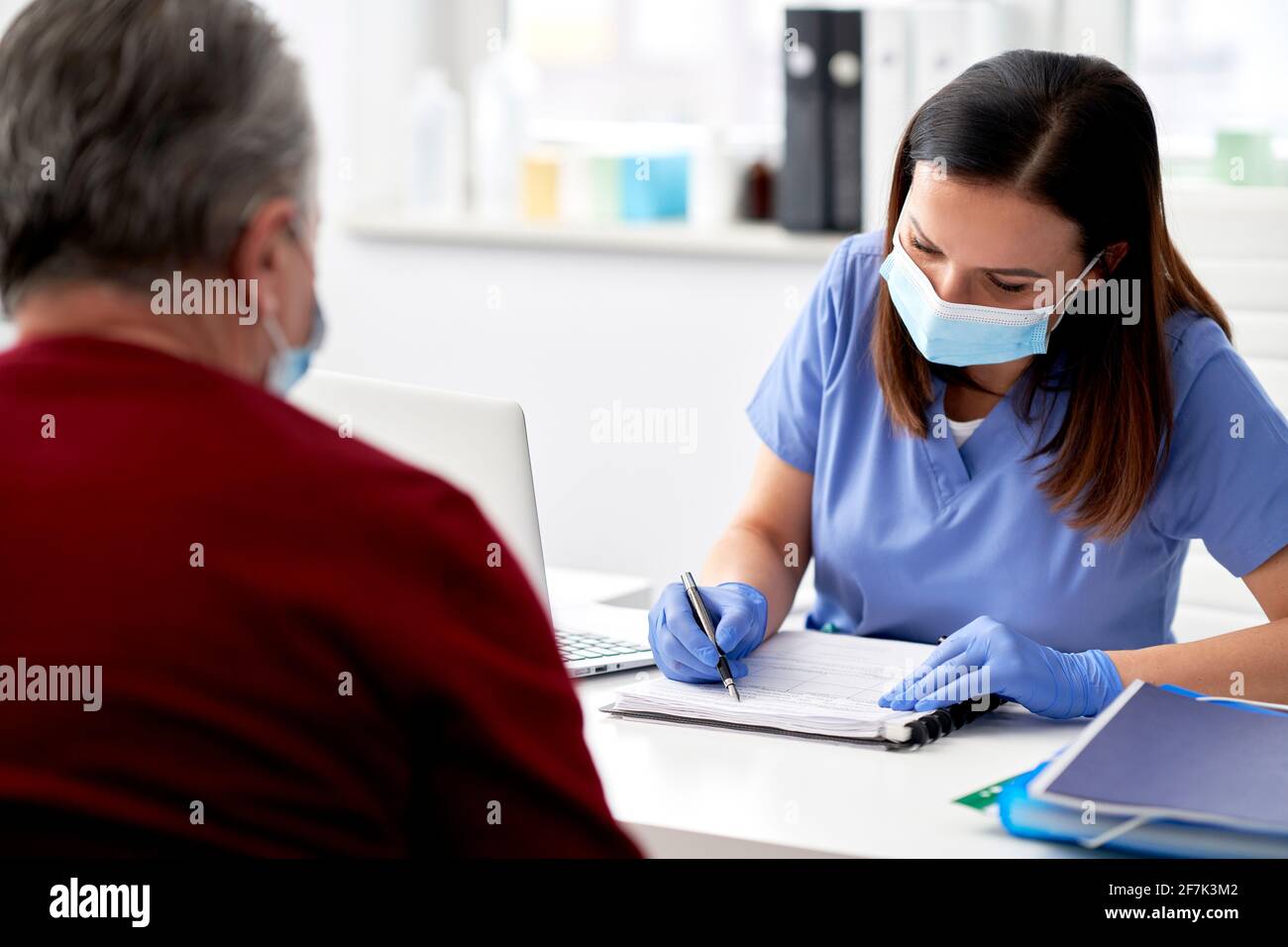 Doctor writing medical prescription senior hi-res stock photography and ...