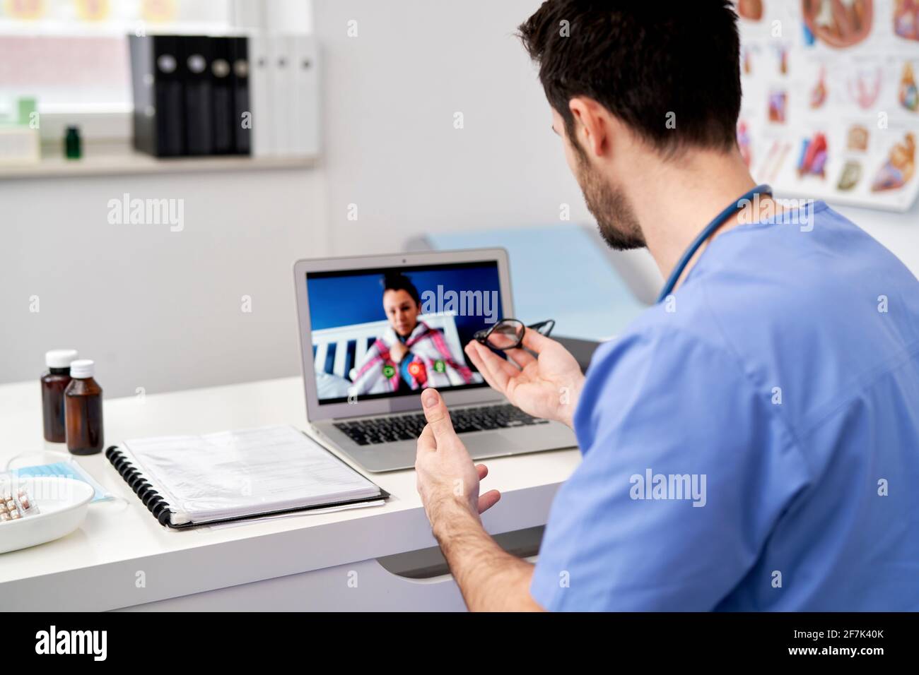 Rear view of doctor making an online consultation Stock Photo - Alamy