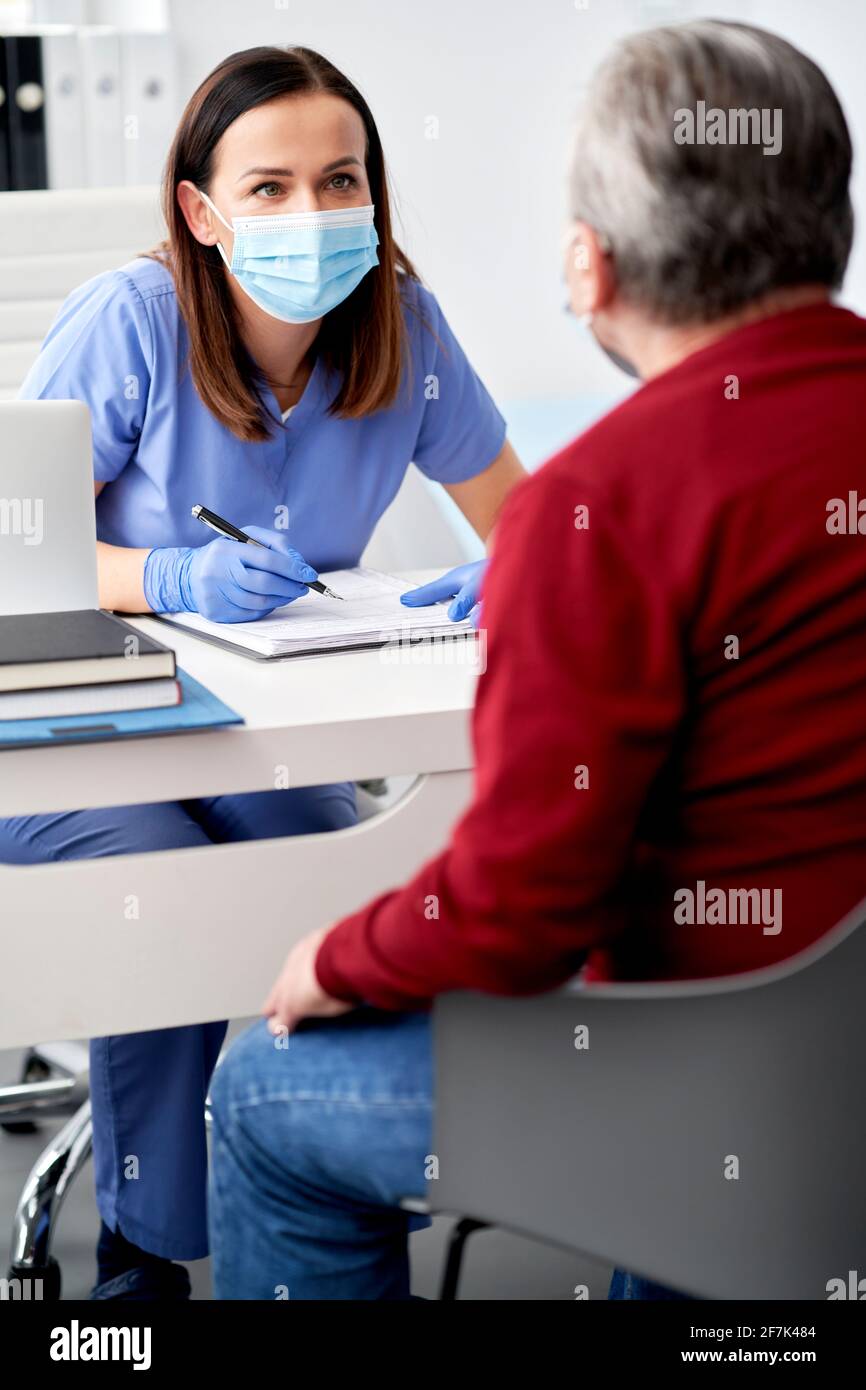 Female doctor conducts a medical interview with the senior patient ...