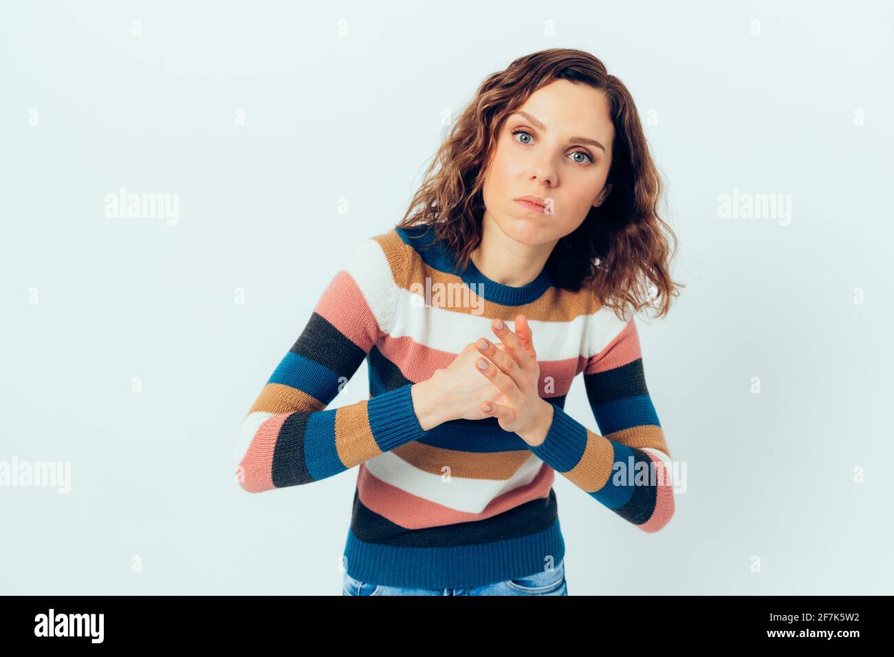 Young woman shows her fist banging against her palm as sign of ...