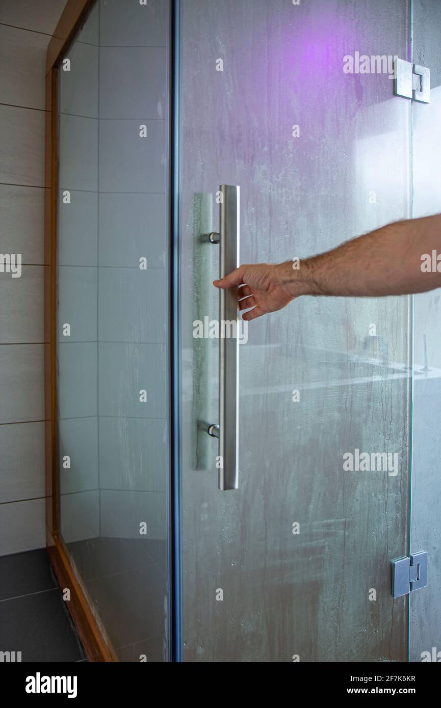 Man open the door on the steam bath in the bathroom Stock Photo - Alamy