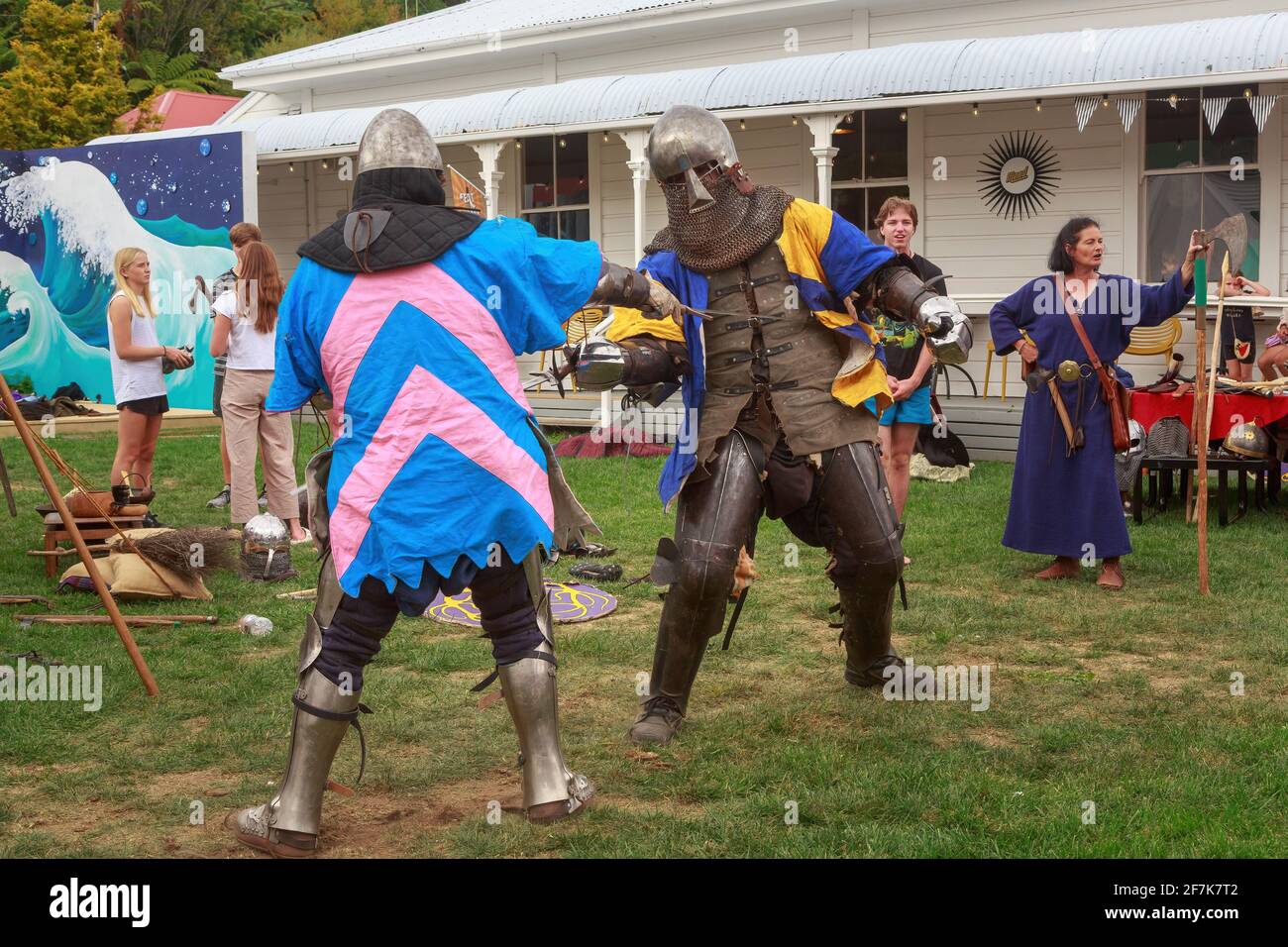 Medieval reenactors dressed as armored knights fighting with swords at ...