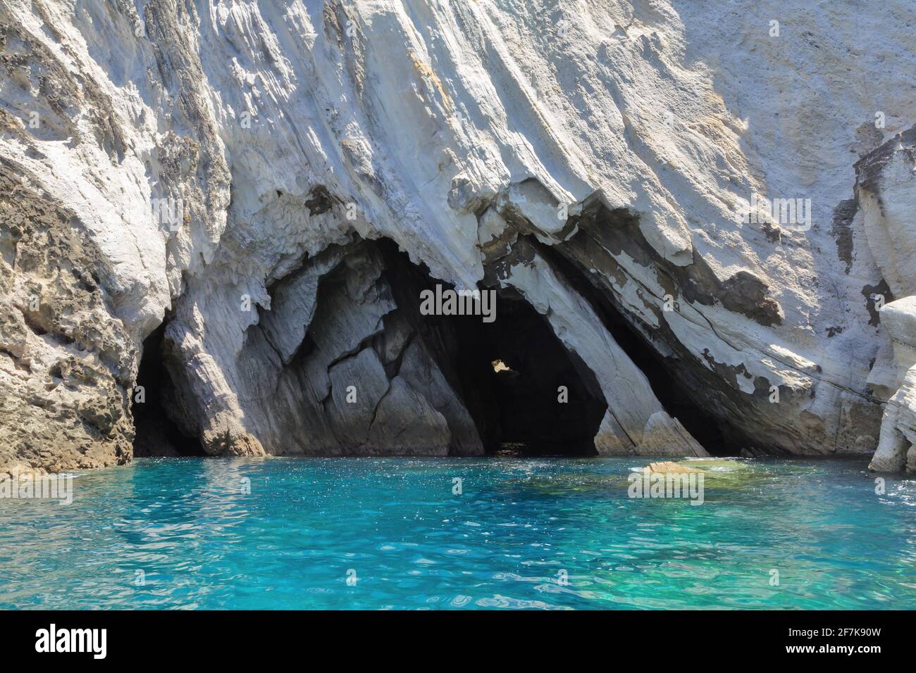 A sea cave in steep white coastal cliffs. Coromandel Peninsula, New ...