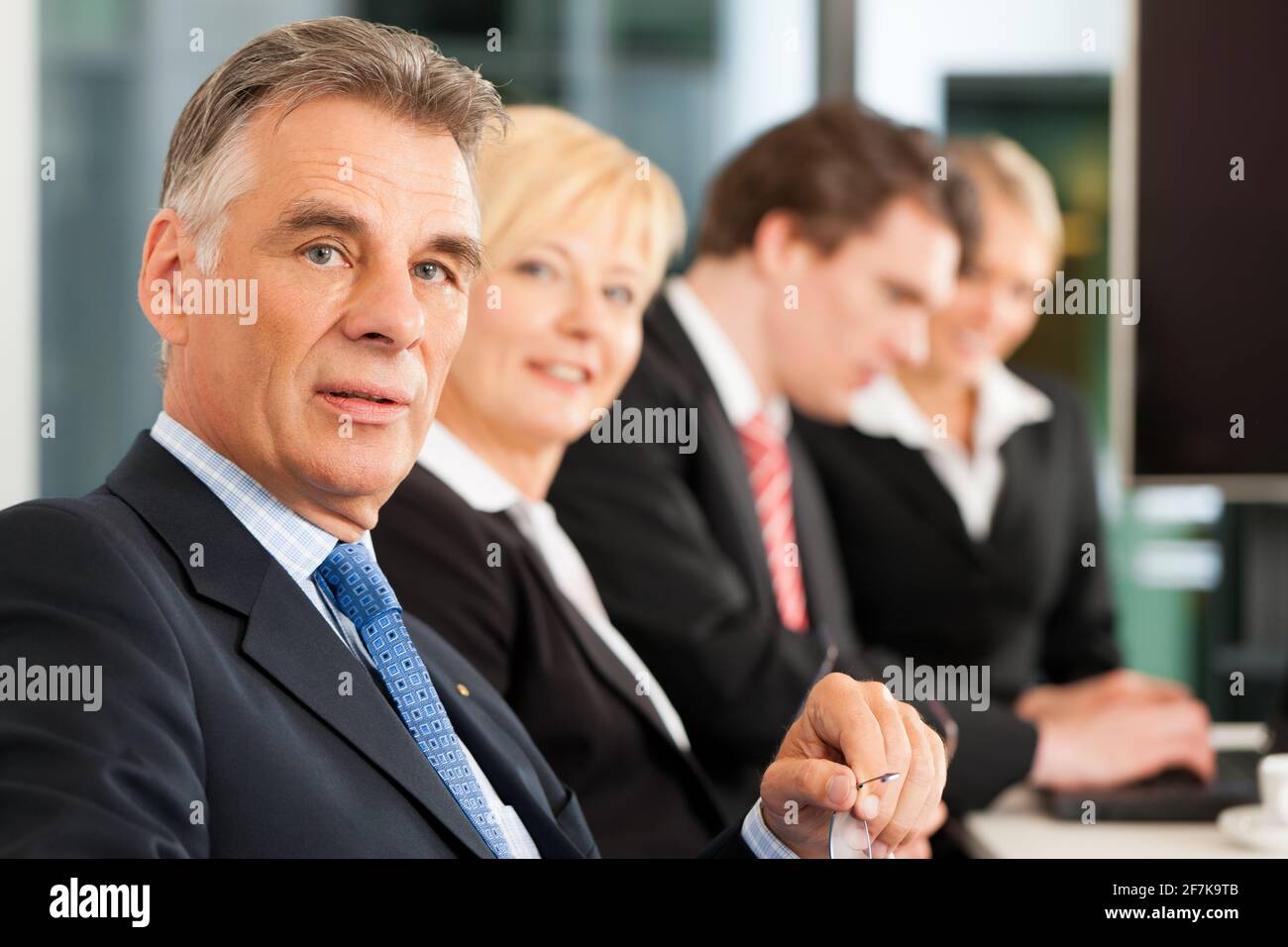 Business - team in an office; the boss is looking into the camera Stock ...