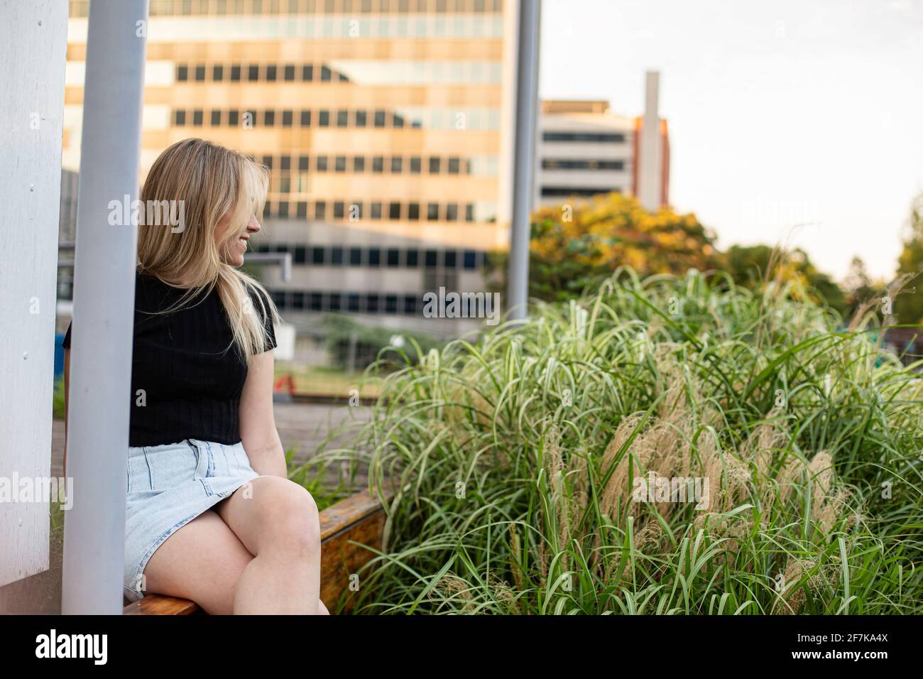 Young european white model woman sitting outside Stock Photo - Alamy