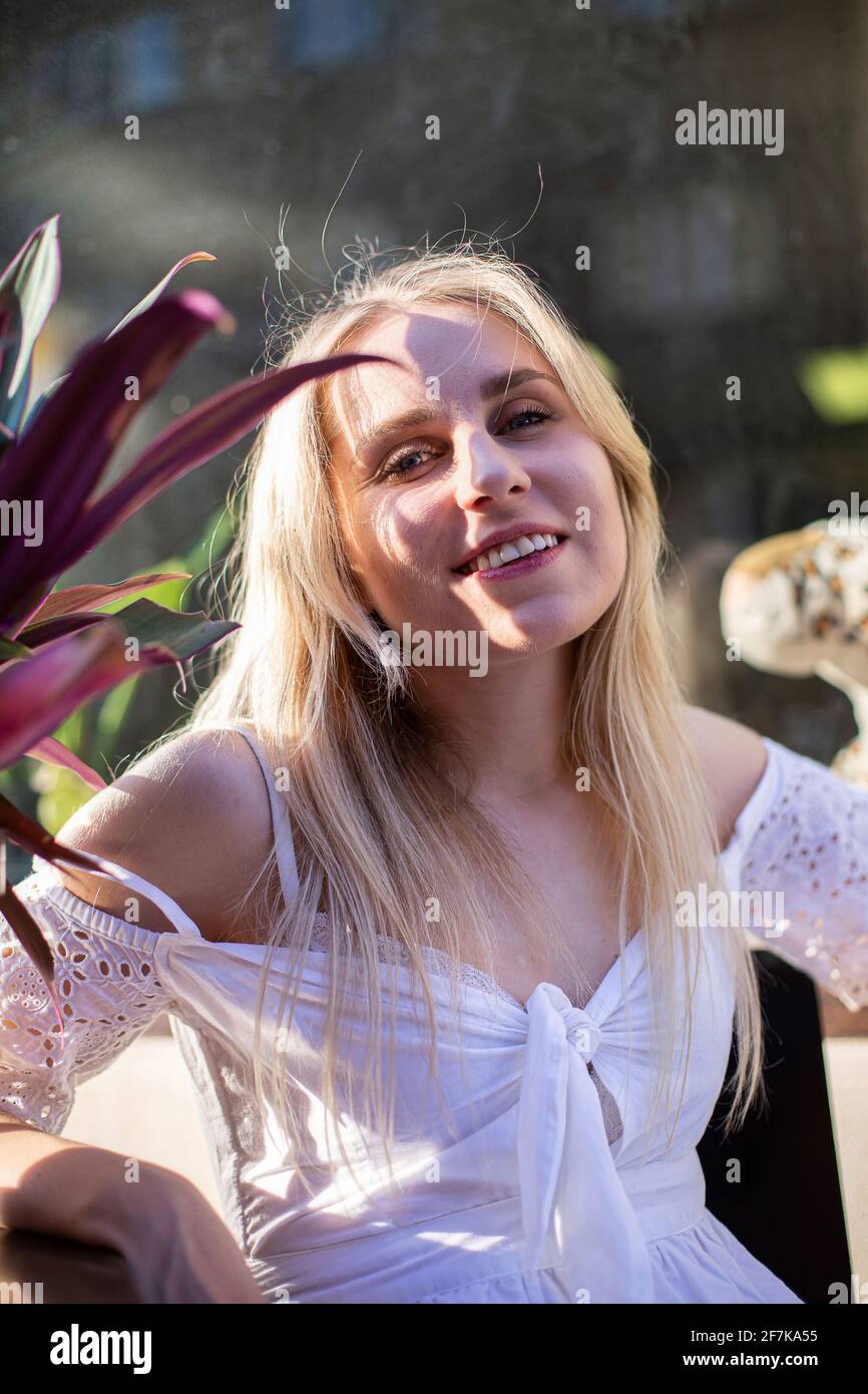 Romantic blond hair european white model with a plant Stock Photo - Alamy