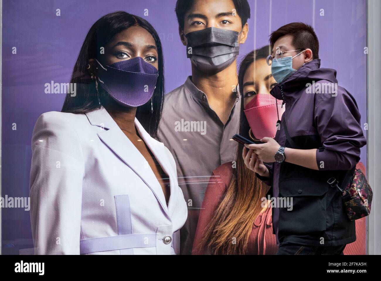 A pedestrian wearing a facemask as a preventive measure against the ...