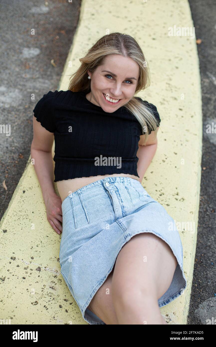 Young european white model woman lying on asphalt road Stock Photo - Alamy