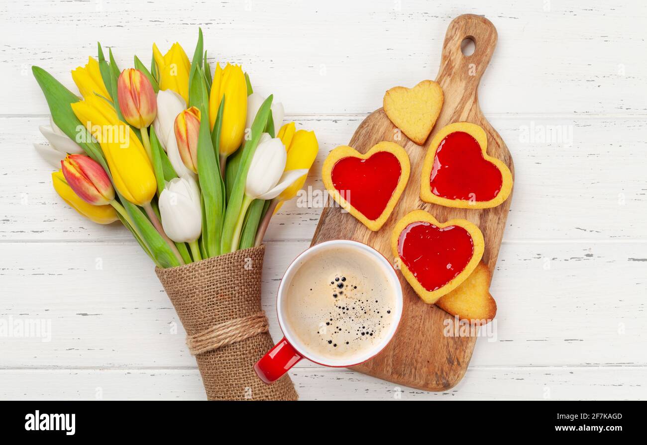 Colorful tulip flowers bouquet, heart shaped cookies and coffee. Top ...