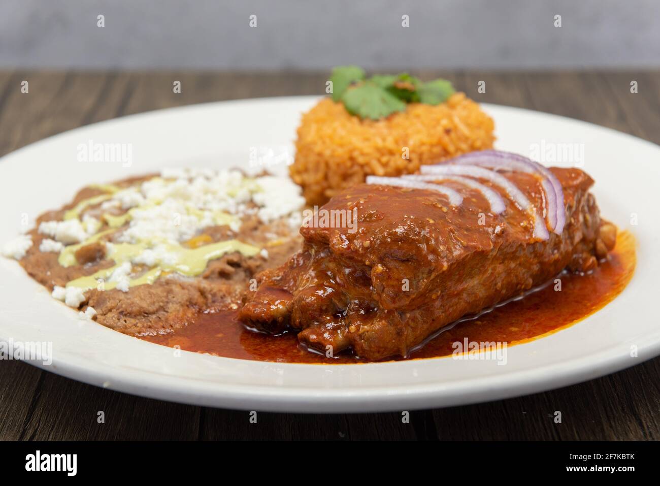 Large slap of Chile Colorado entree meat, refried beans, and rice ...