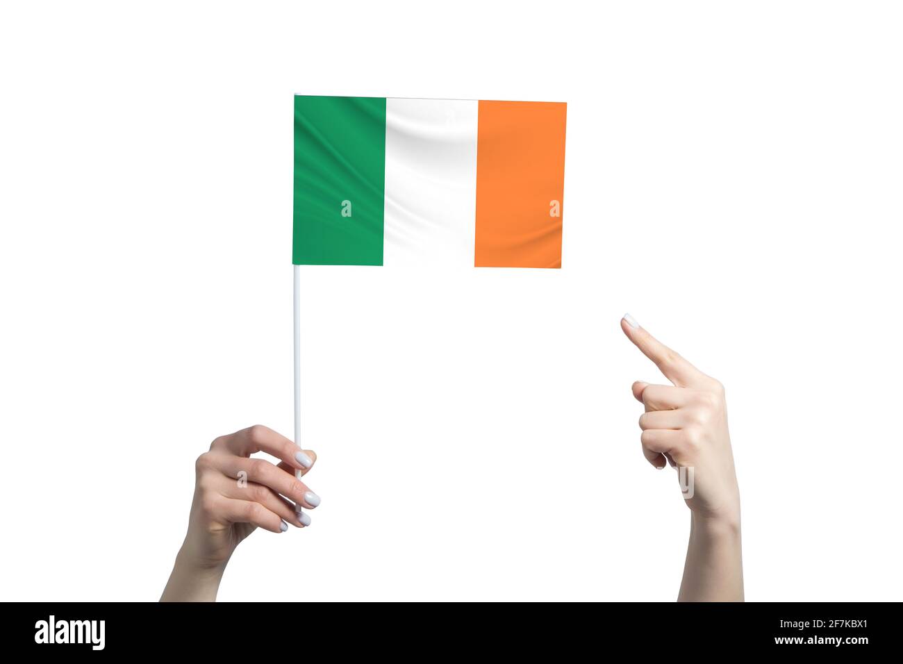A beautiful female hand holds a Ireland flag to which she shows the ...