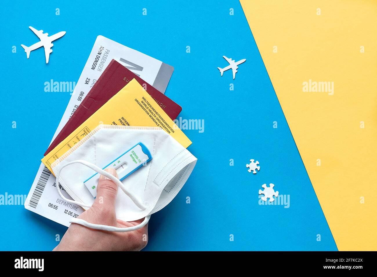 New normal travel during COVID-19 restrictions, flat lay on blue yellow ...