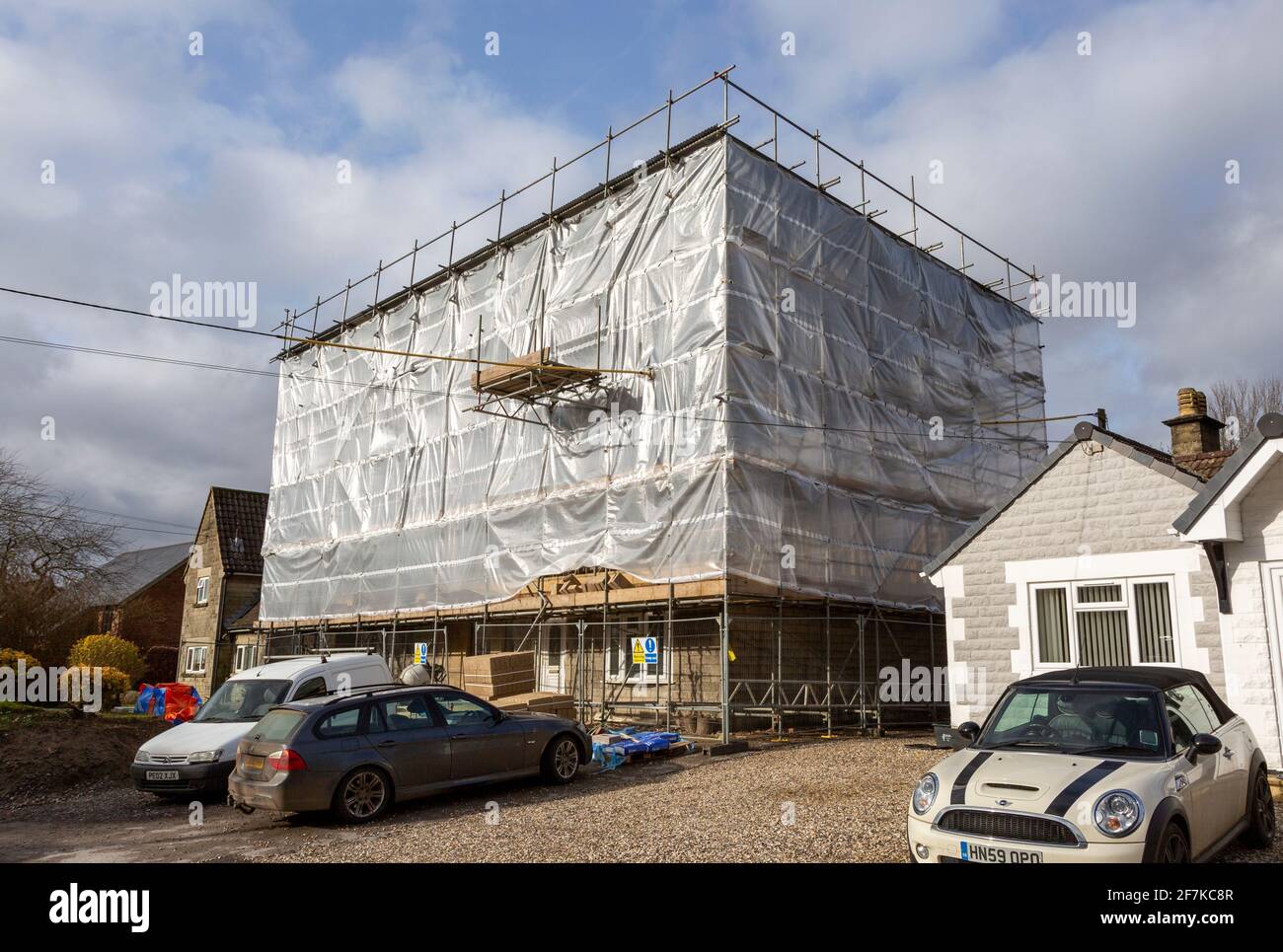 Scaffolding and protective screen around house undergoing major ...