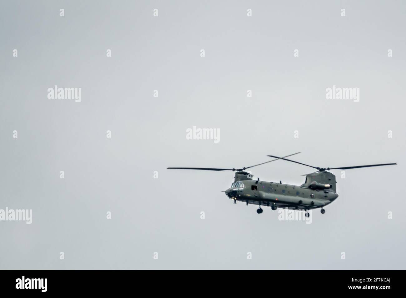 RAF Chinook helicopter (Boeing HC.MK 6) flying set against a cloudy ...