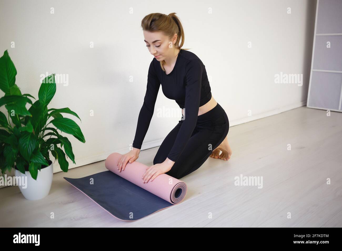 woman unfold yoga mat preparing for practice Stock Photo - Alamy