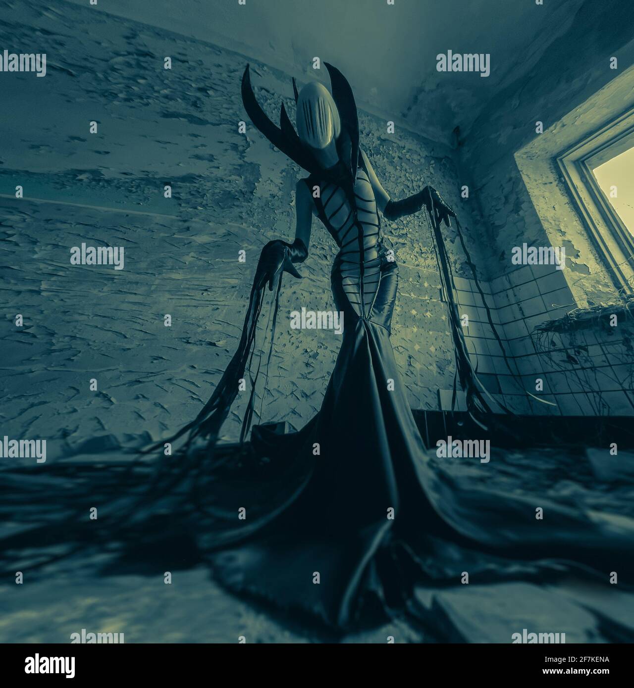 Woman in the image of the alien creature stands inside old abandoned ...