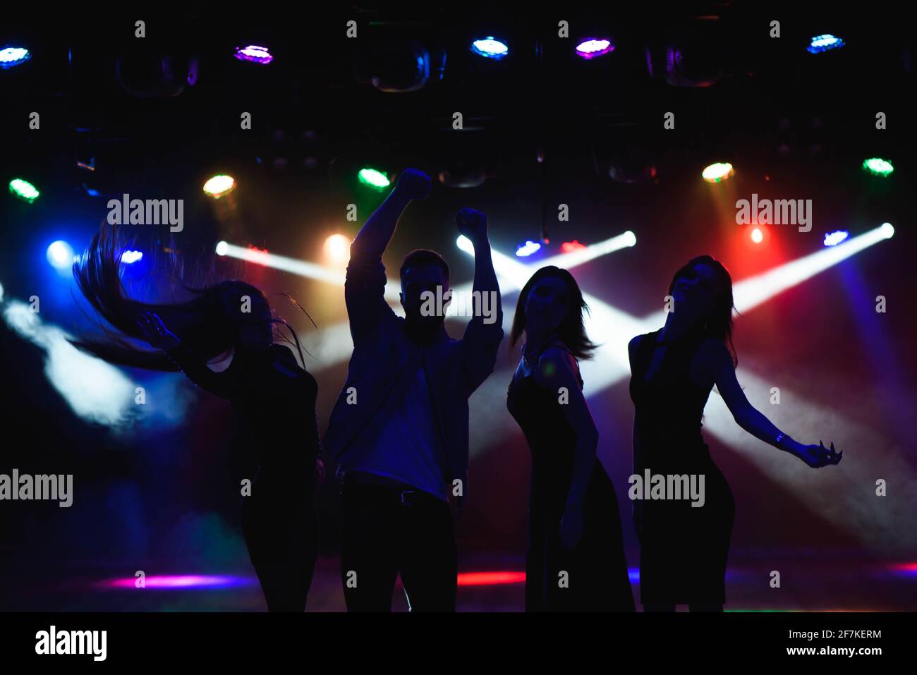 Nightlife and disco concept. Young people are dancing in club Stock ...