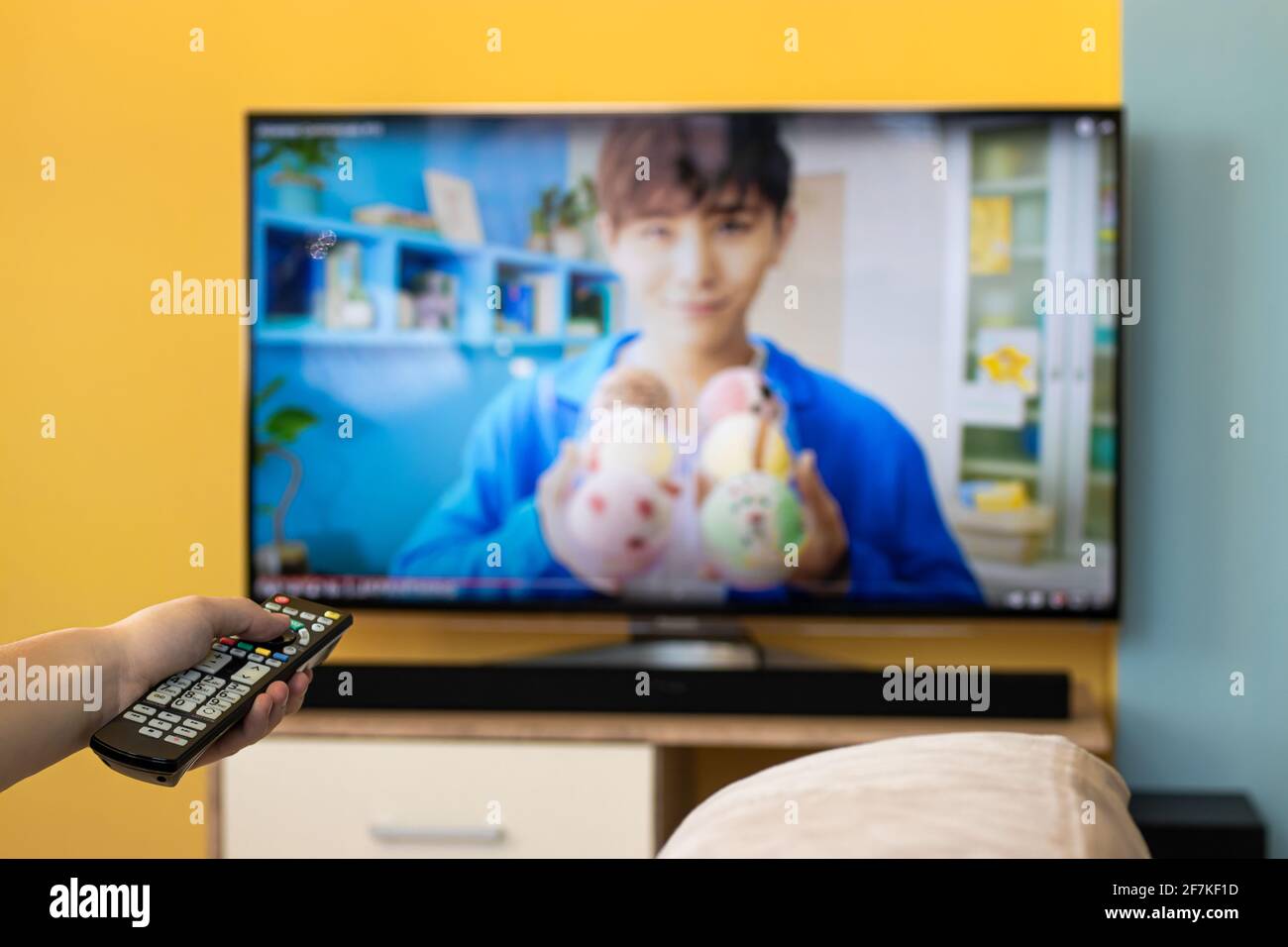 Watching television and changing channels with TV remote Stock Photo ...