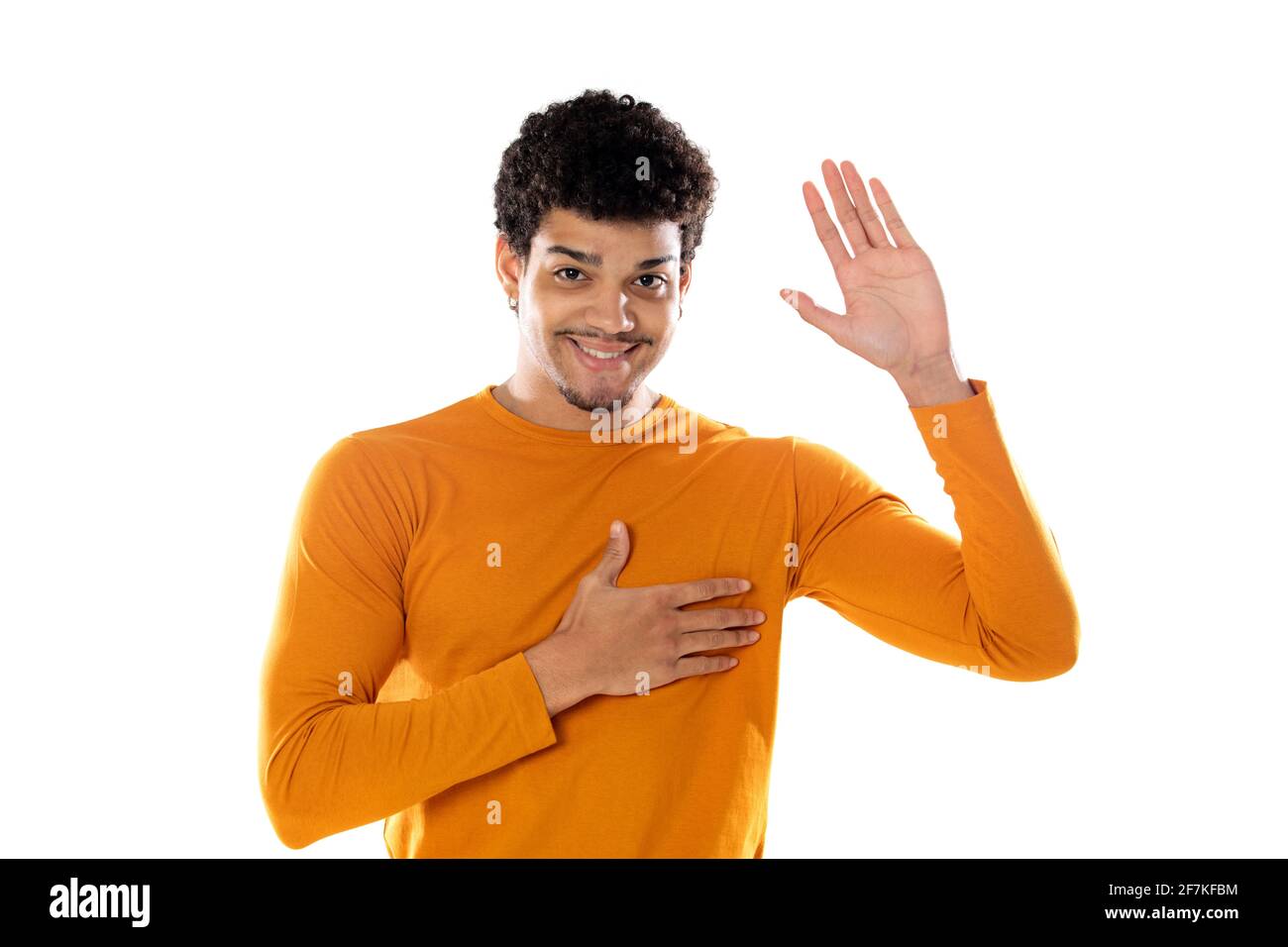 Handsome afro guy with his right hand on the heart isolated on a white ...