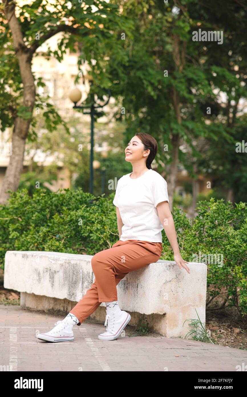 beautiful young woman resting in park Stock Photo - Alamy