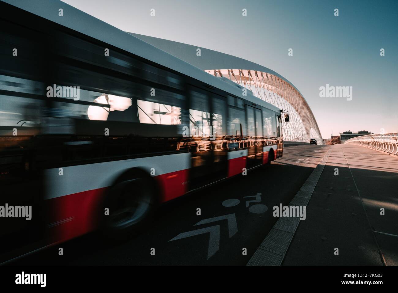 Blurred public transport bus rushing on modern architecture bridge ...
