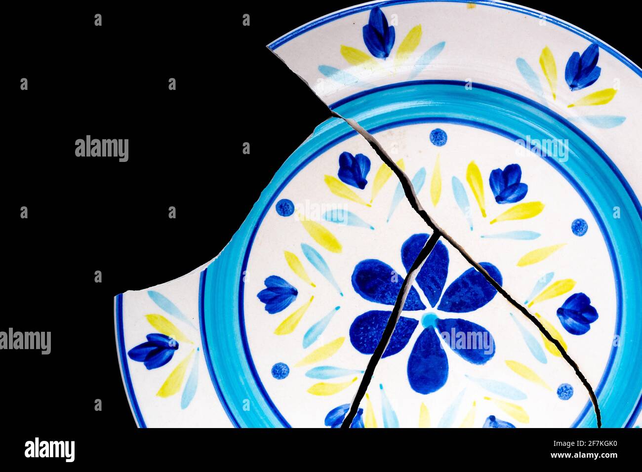 Broken ceramic plate on black background. Made in natural light Stock ...