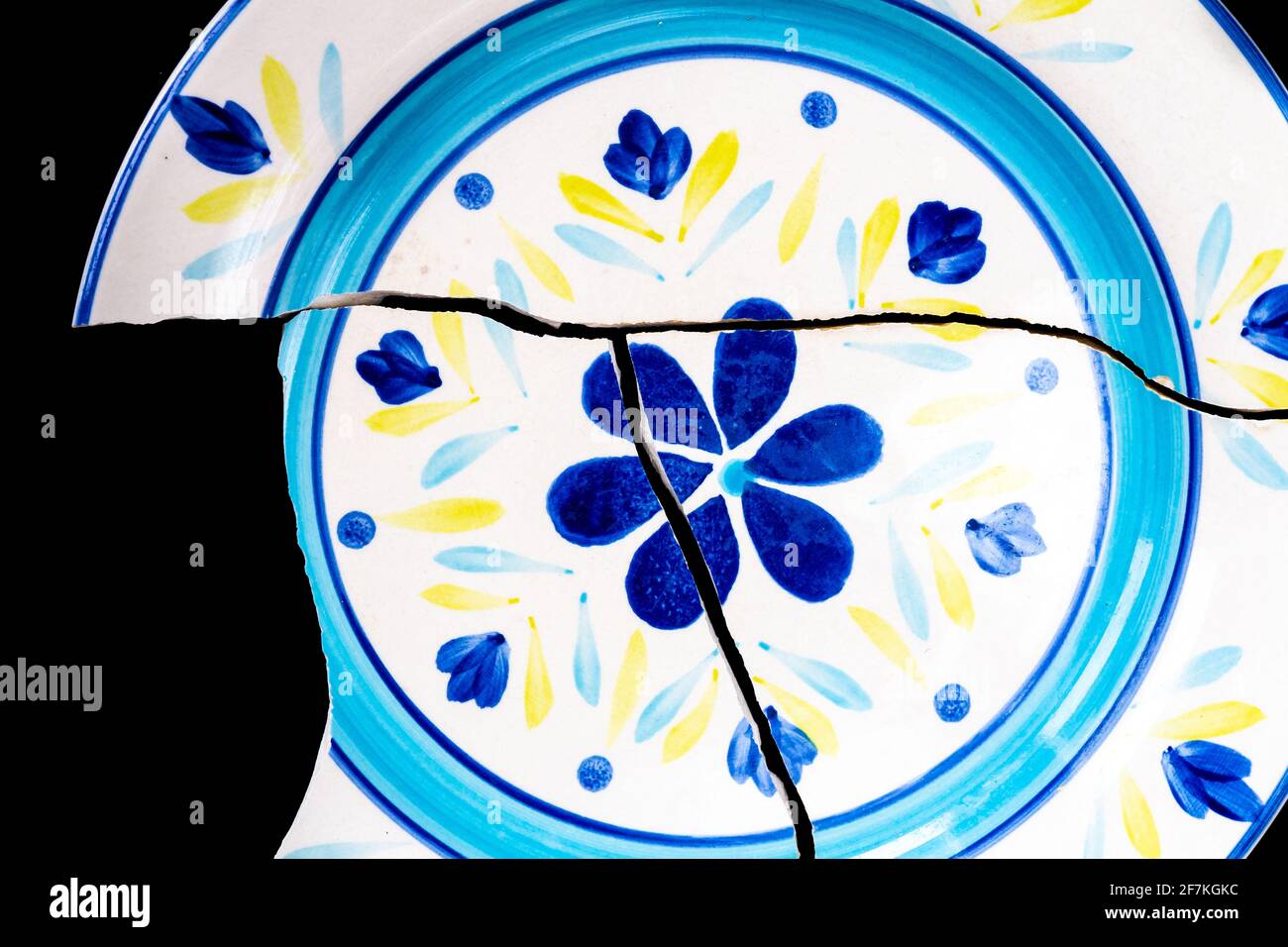 Broken ceramic plate on black background. Made in natural light Stock ...