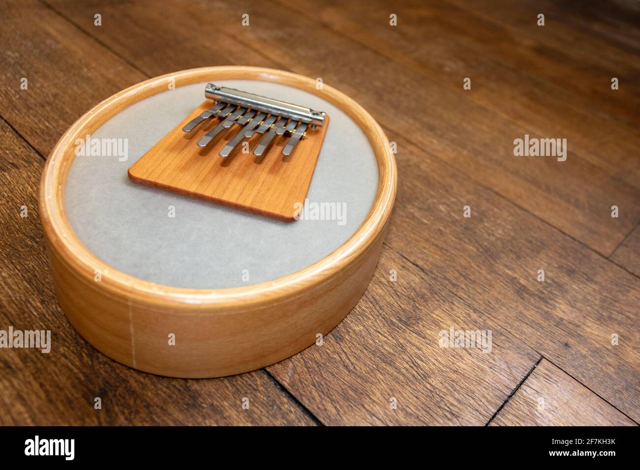 Sansula or kalimba instrument with membrane on a wooden floor ...