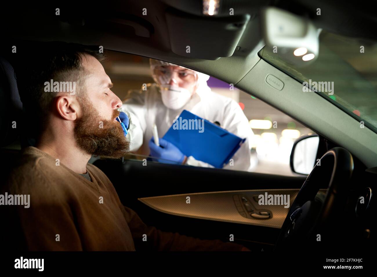 Medical worker performing drive thru hi-res stock photography and ...