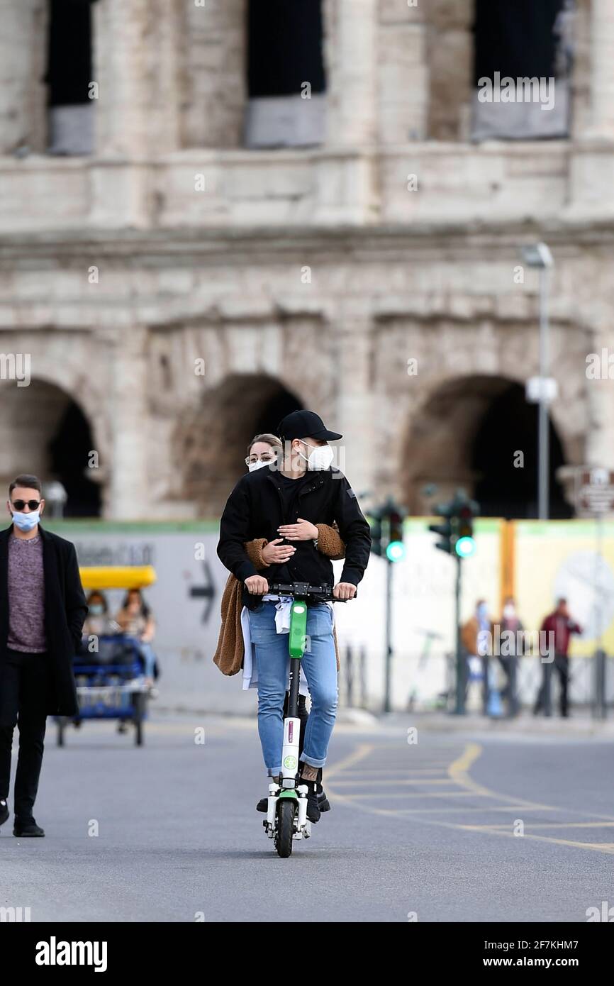 Italy, Rome, March 13, 2021 : Two people riding an electric scooter ...