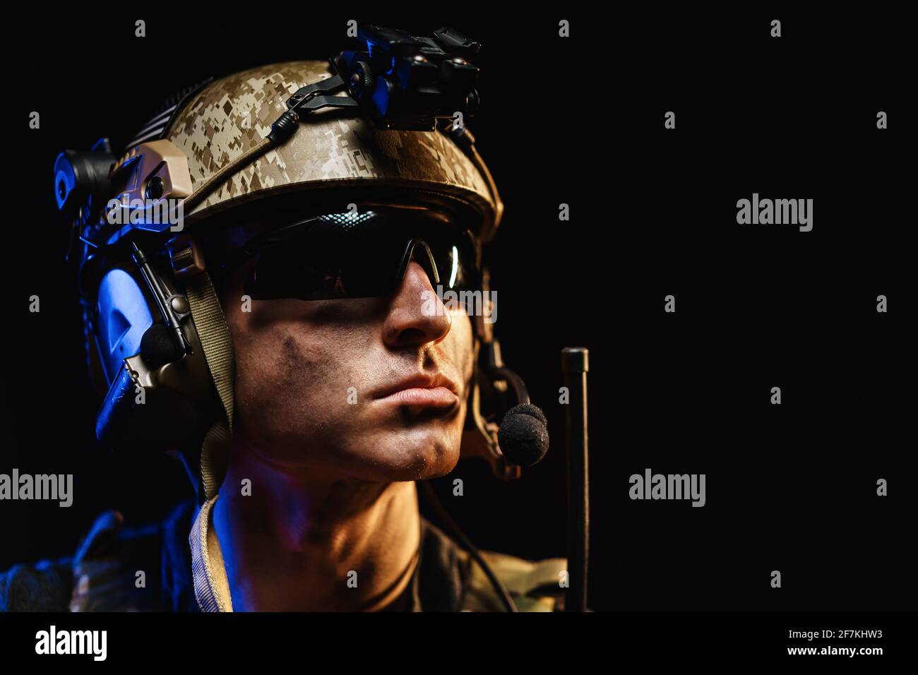 Portrait of special forces soldier in helmet and glasses in the dark ...