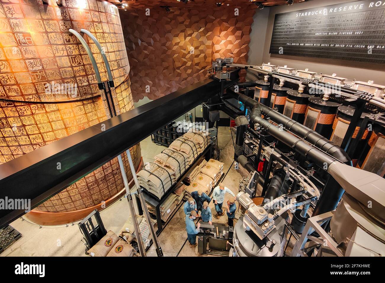 SHANGHAI, CHINA - APRIL 8, 2021 - Staff members work in front of huge ...