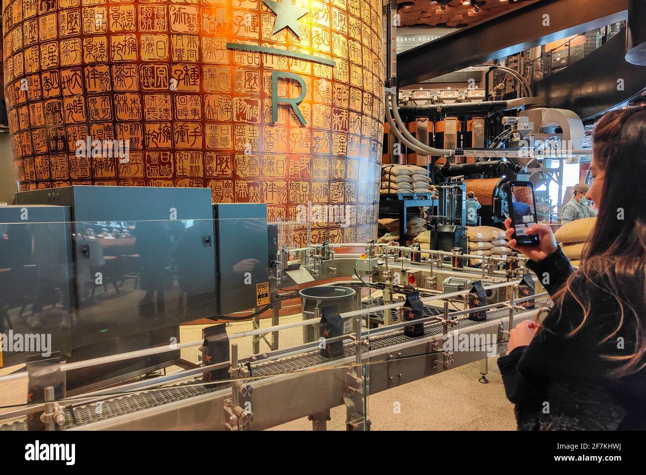 SHANGHAI, CHINA - APRIL 8, 2021 - Staff members work in front of huge ...