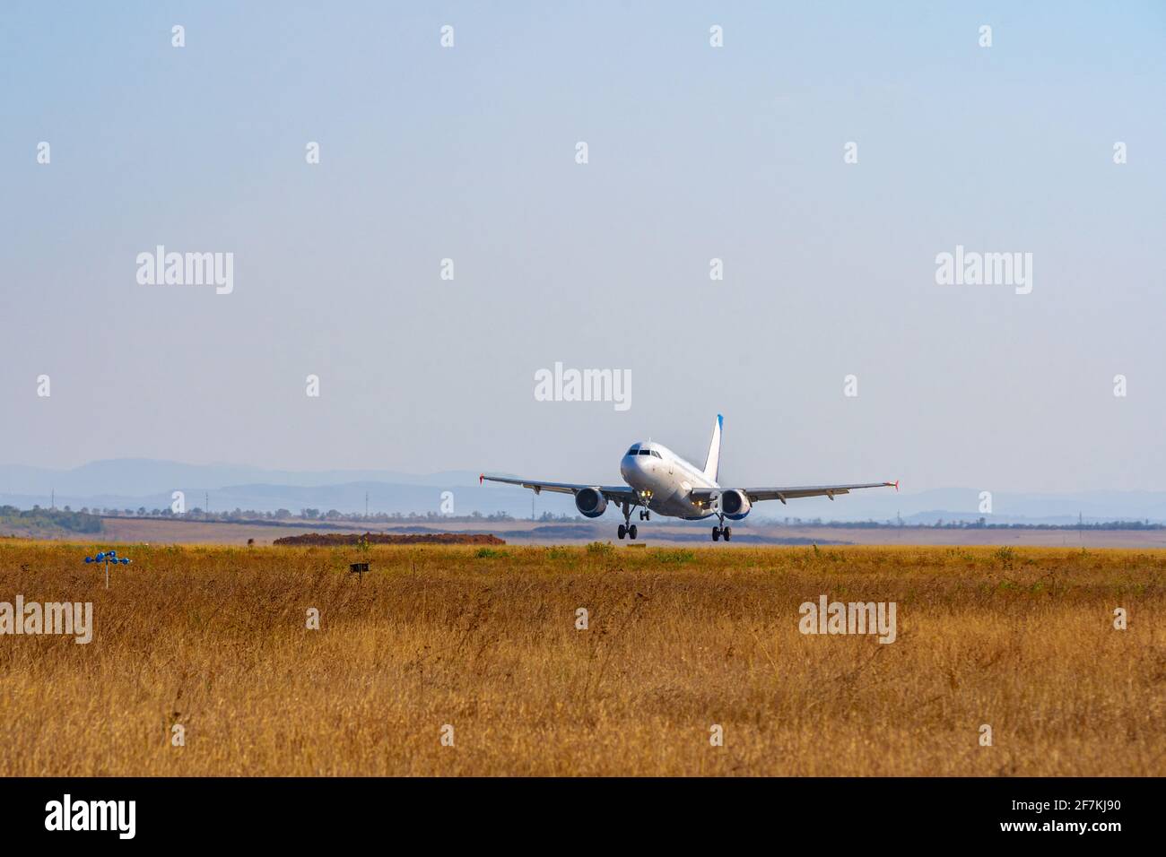 Passenger plane takes off from runway in airport Stock Photo - Alamy