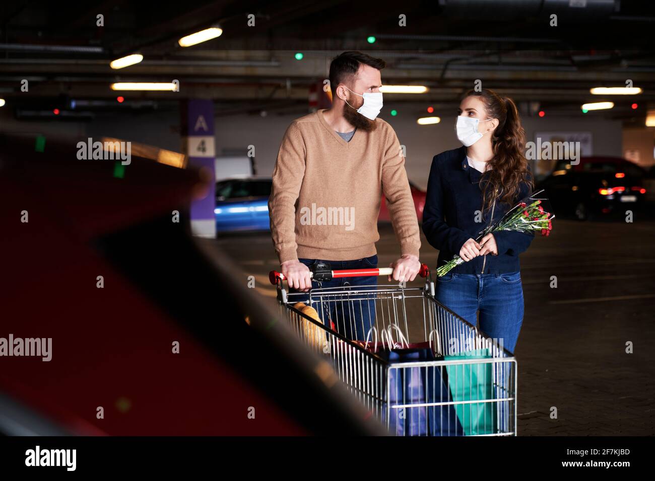 Couple coming back from shopping during pandemic Stock Photo - Alamy