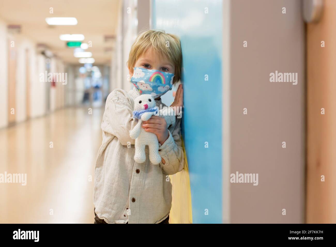 Child, boy, sitting in the waiting room in emergency, waiting for ...