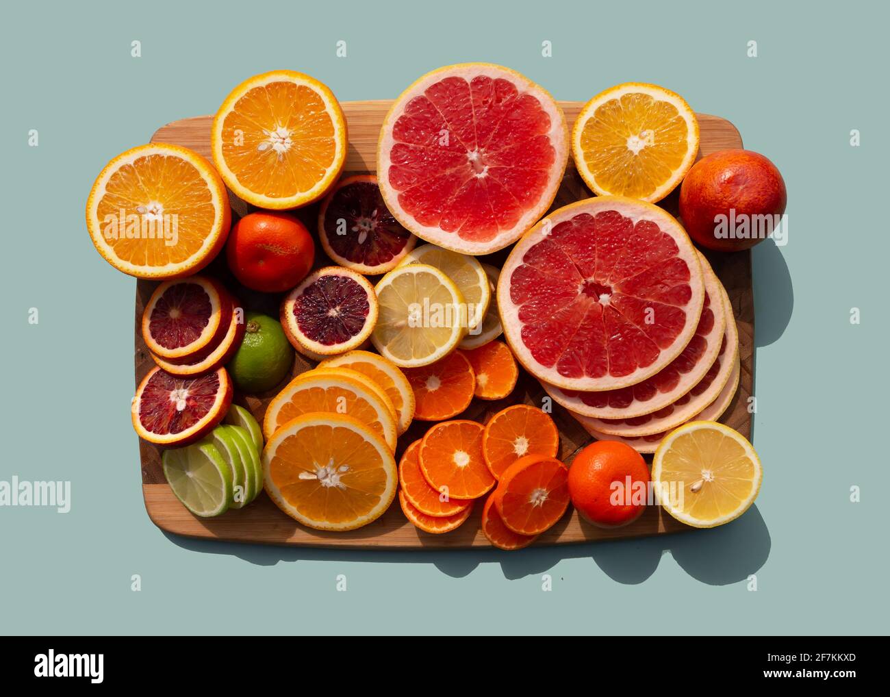 Set of different sliced citrus fruits on wooden board. Orange ...